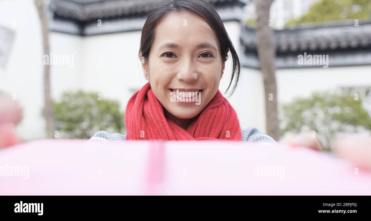Happy woman receiving a gift box in china Stock Photo - Alamy