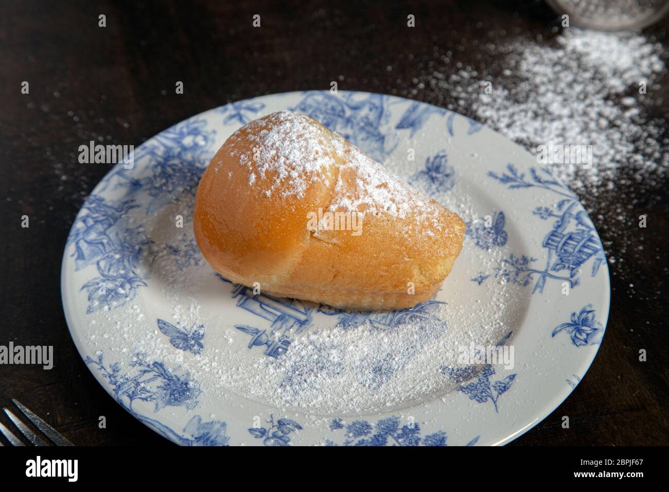 Traditional Baba yeast cake with Neapolitan rum and icing sugar Stock ...