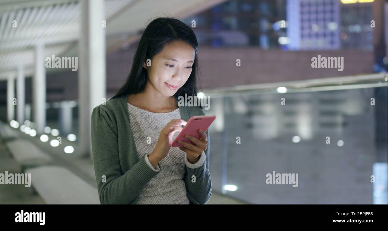 Woman use of mobile phone in city at outdoor Stock Photo - Alamy