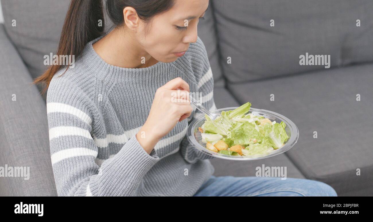 Woman eating salad at home Stock Photo - Alamy