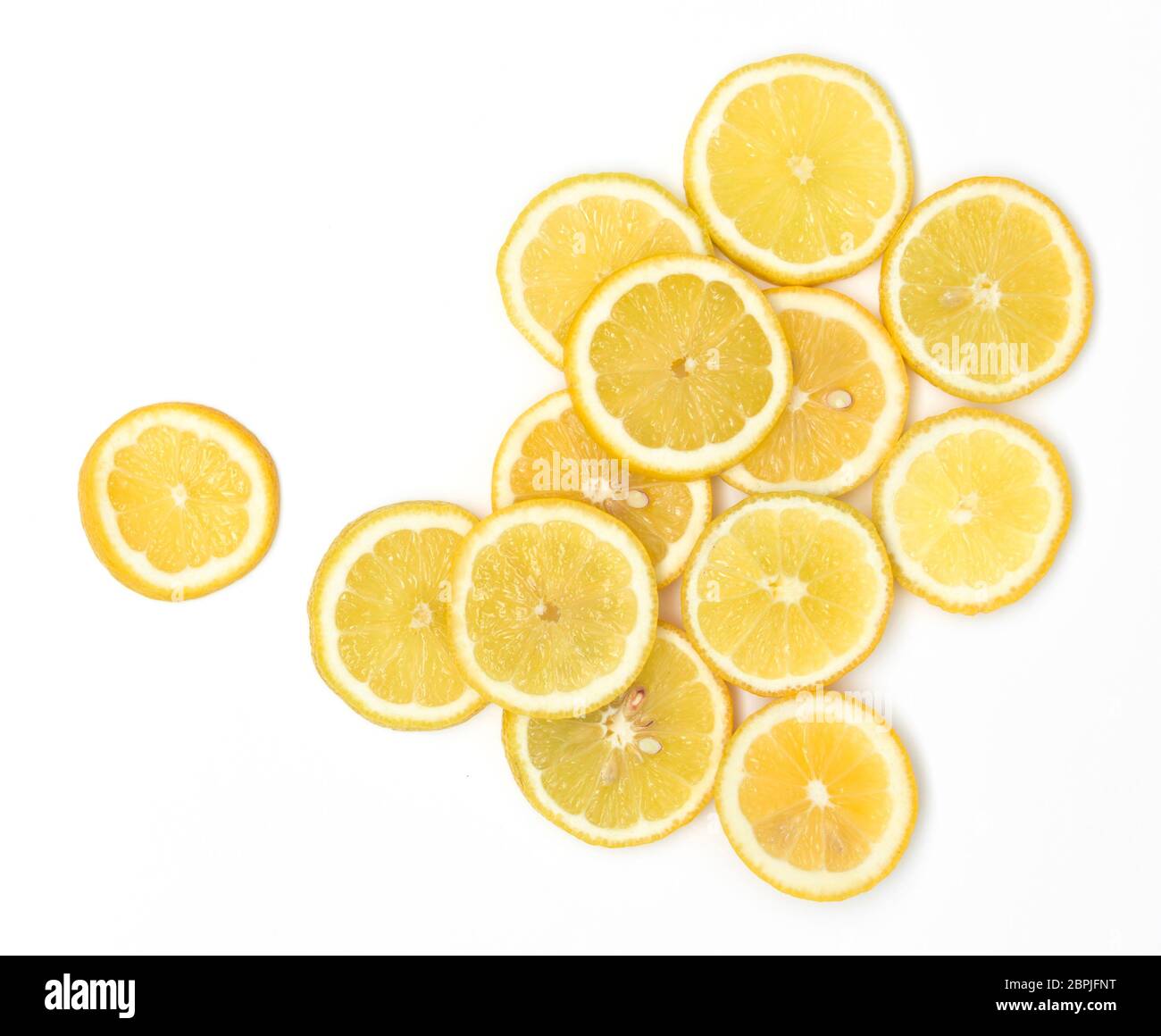 many fresh lemon slices lie beautifully arranged on a white background ...