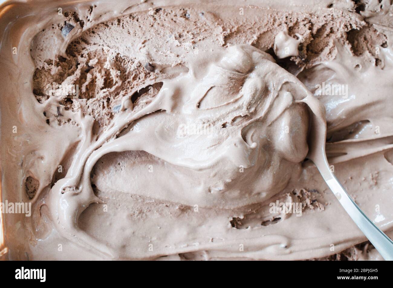 Texture of melting chocolate ice cream. Brown background, close up ...