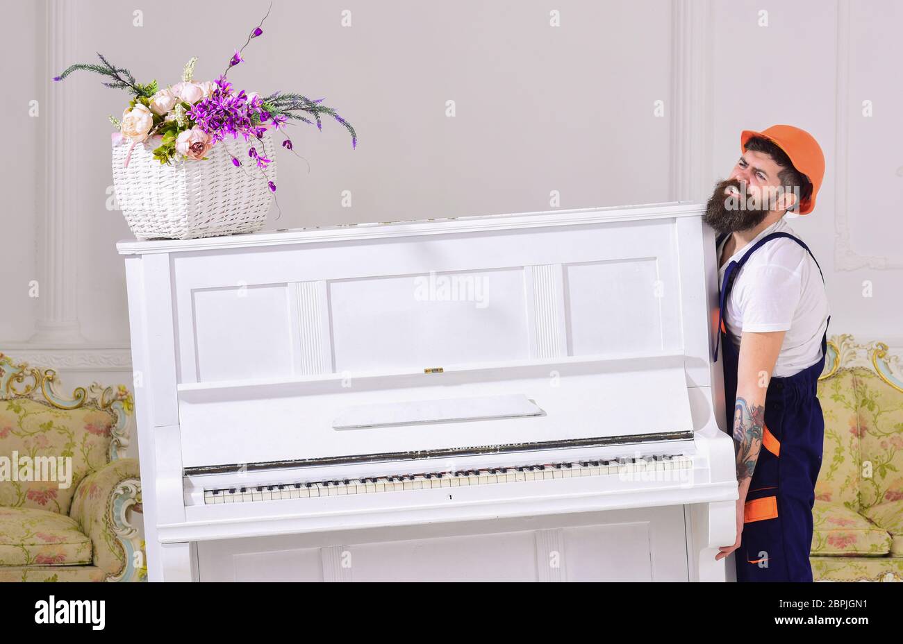 Courier delivers furniture, move out, relocation. Loader moves piano ...