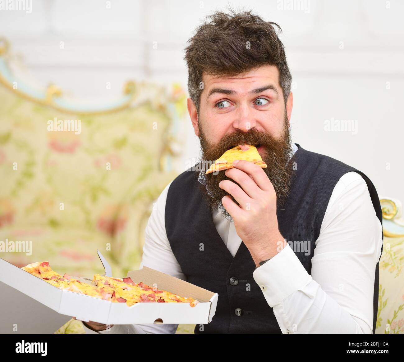Pizza delivery concept. Man with beard and mustache holds box with ...