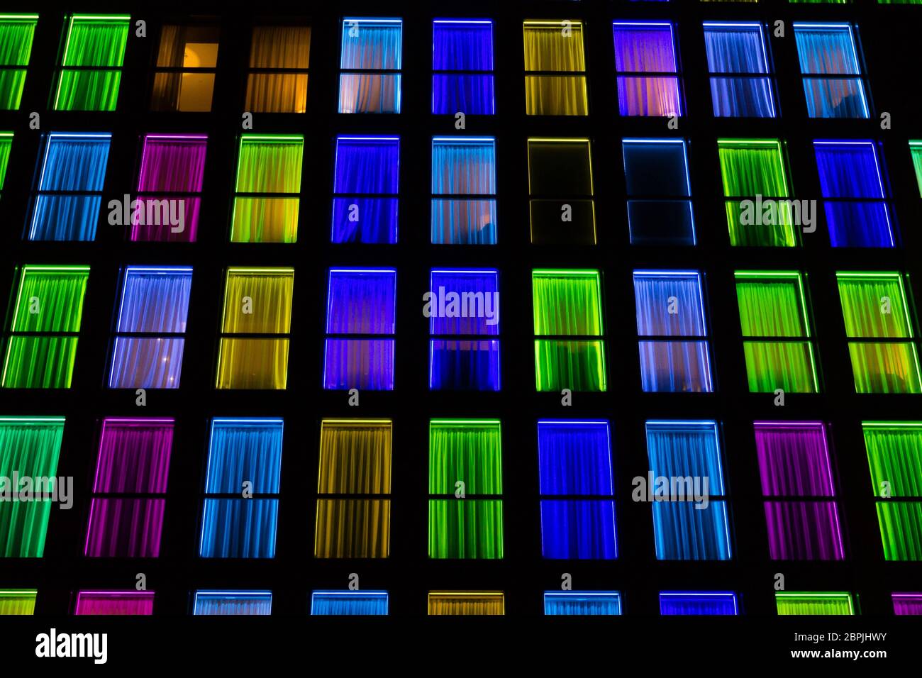 Colored windows texture. Windows illuminated by neon lights background ...