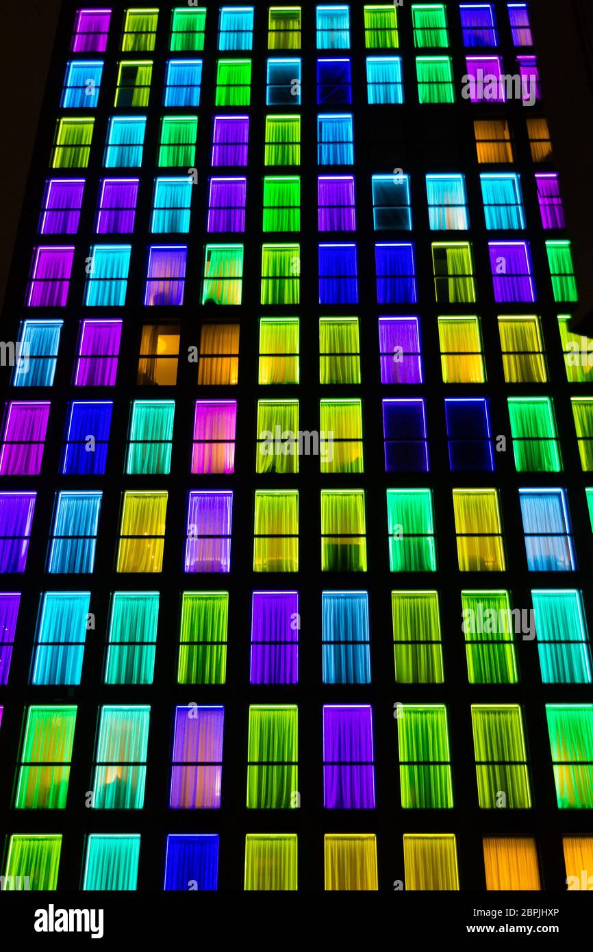 Colored windows texture. Windows illuminated by neon lights background ...