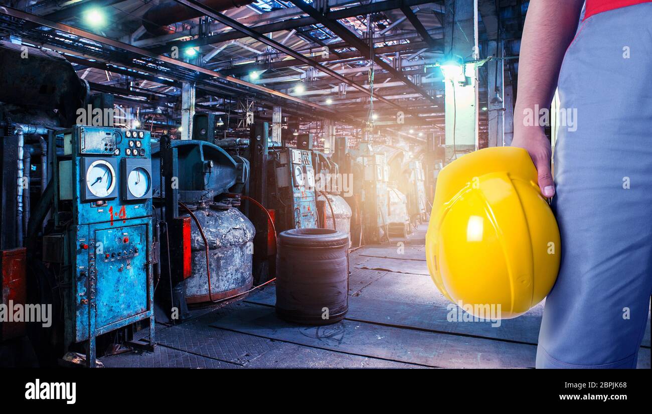 Closeup of worker man with yellow helmet on Industrial zone background ...