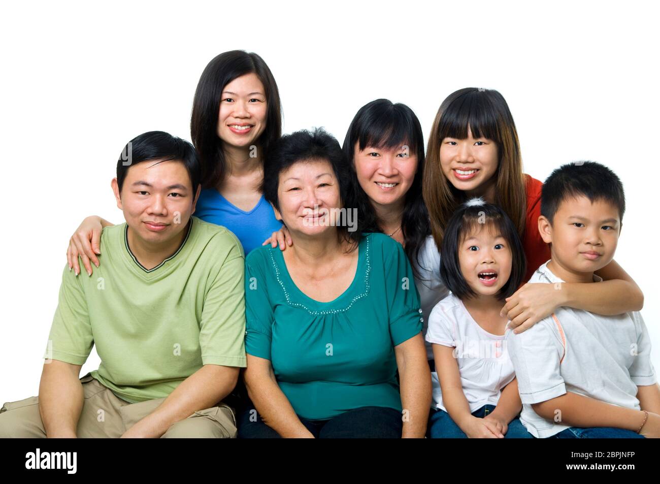 Larger Asian family portrait on white background, three generations ...