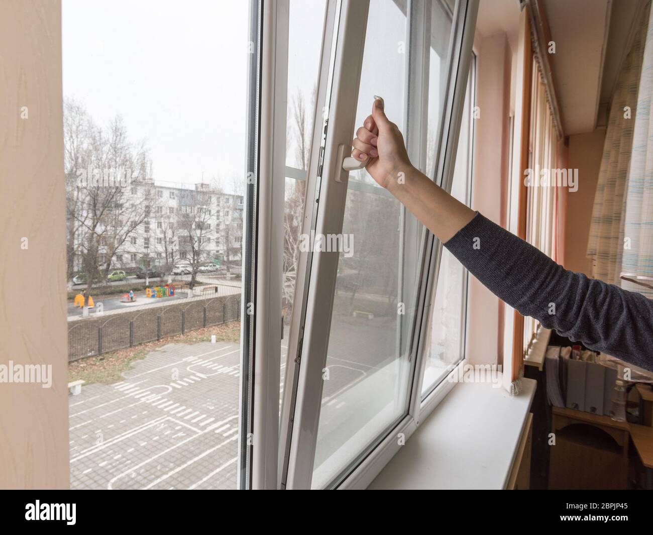 A hand opens a window to air the room Stock Photo - Alamy