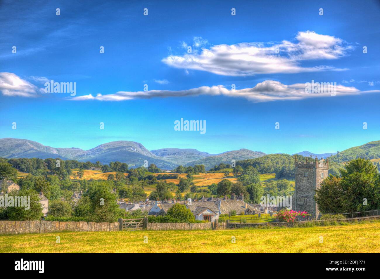 Hawkshead village Cumbria The Lake District with blue sky church and ...