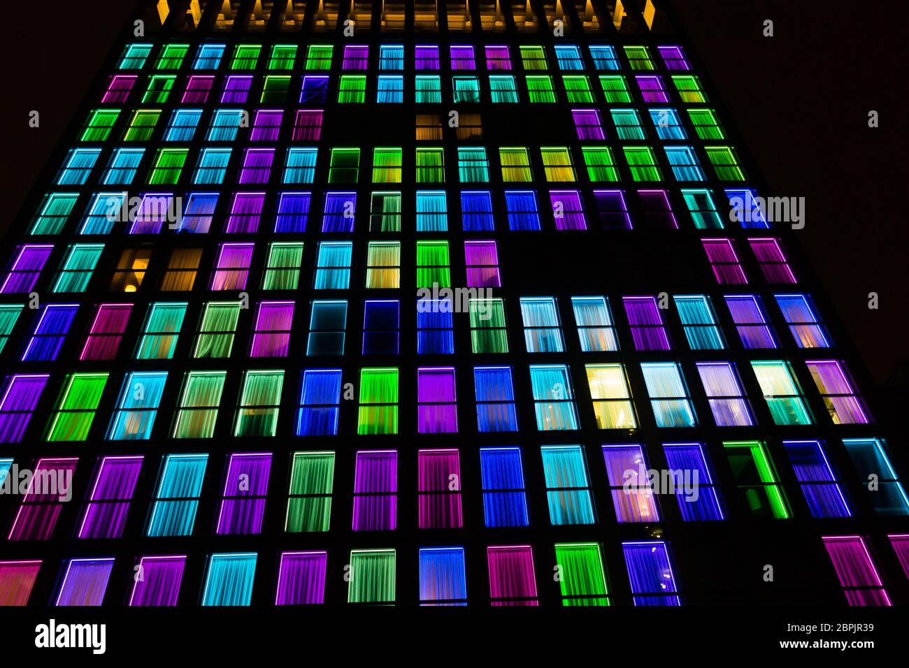 Colored windows texture. Windows illuminated by neon lights background ...