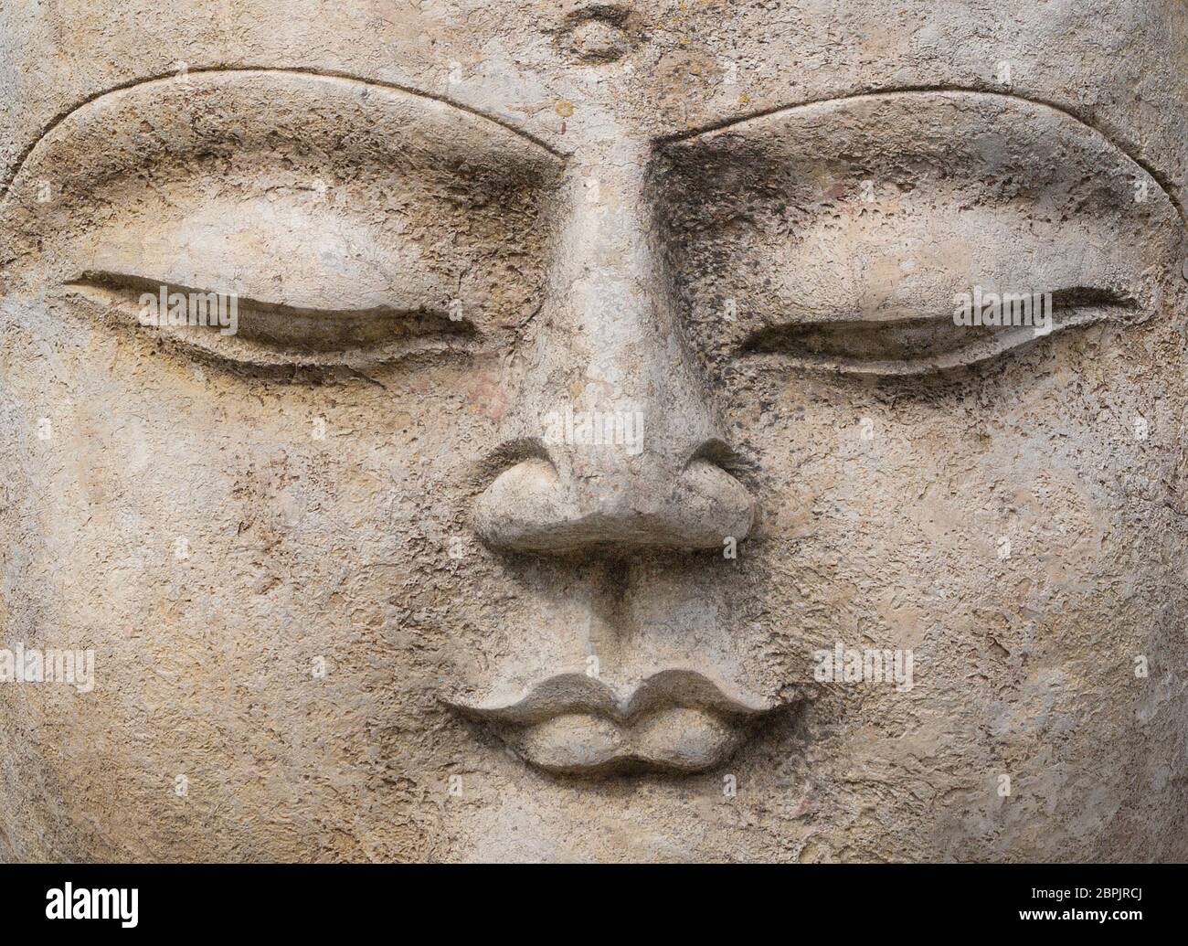 Buddha face made of stone. Religion of Buddhism Stock Photo - Alamy