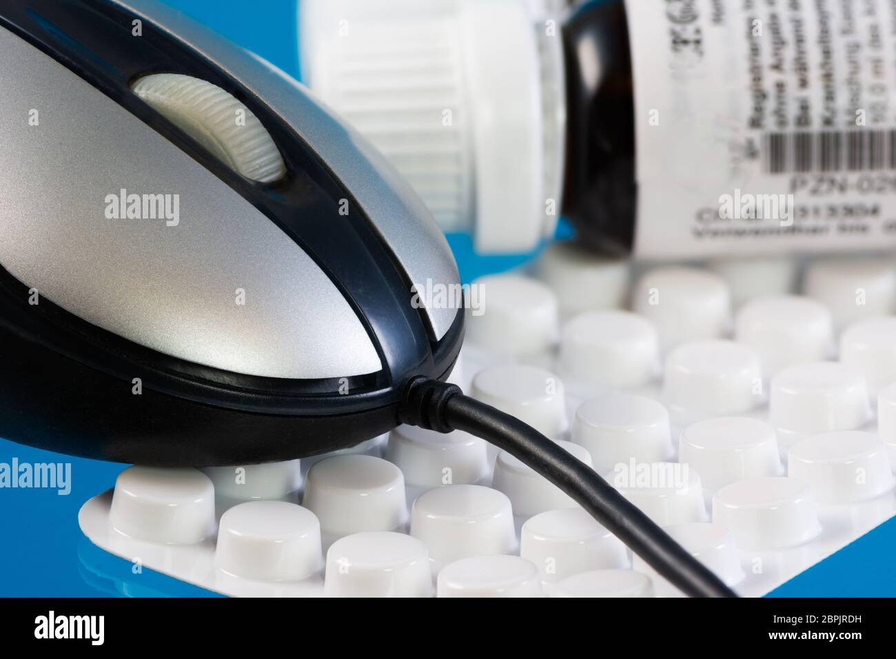 Mouse and pills as symbol for online ordering of medicine in an ...