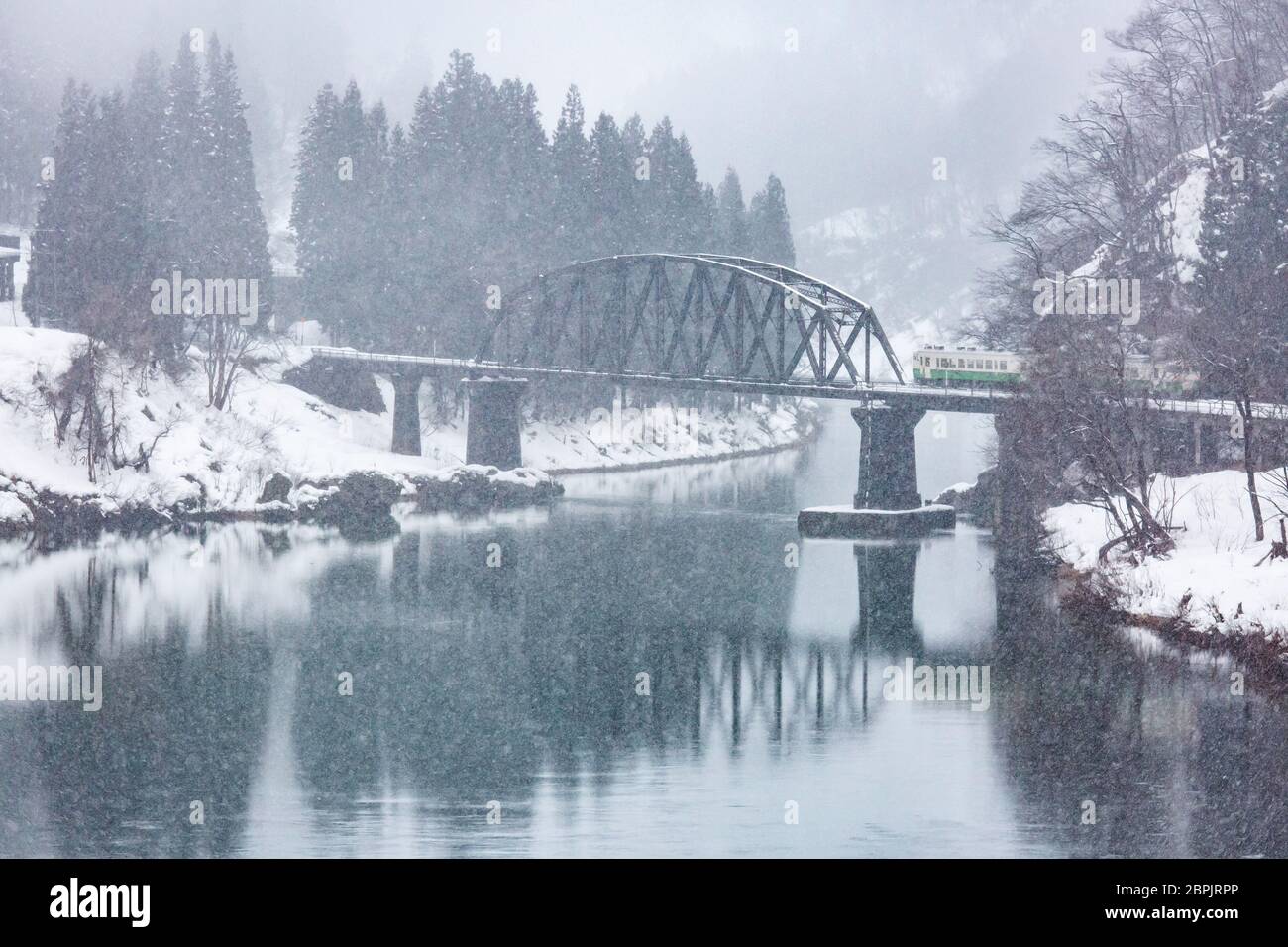 Train in Winter landscape snow on bridge Stock Photo - Alamy