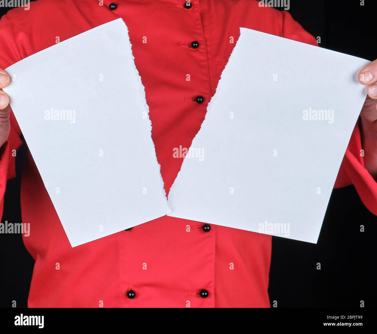 man in a red uniform holds a white sheet of paper torn in half, black ...