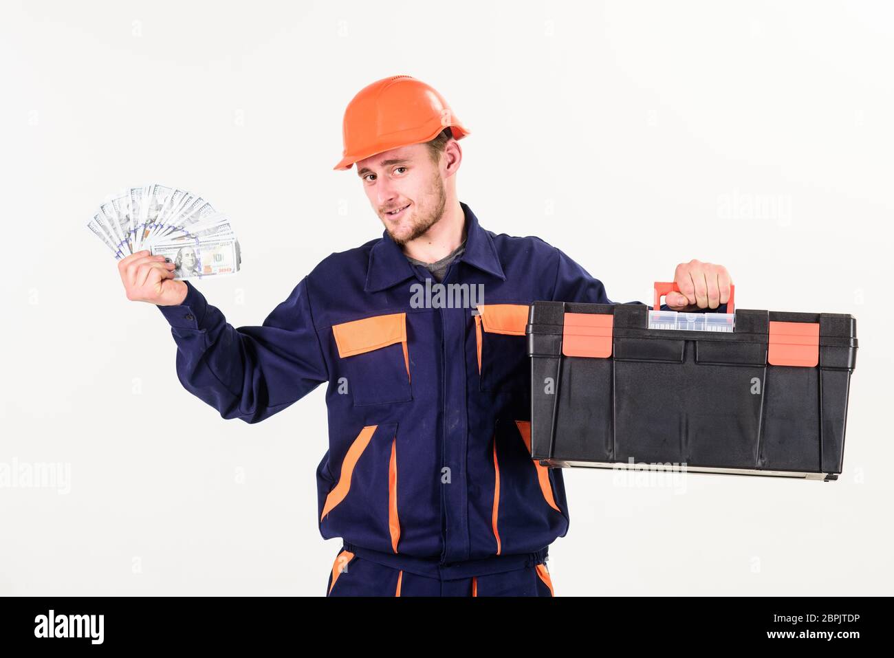 Builder earn money, repairman holds cash, banknotes in hand. Man with ...