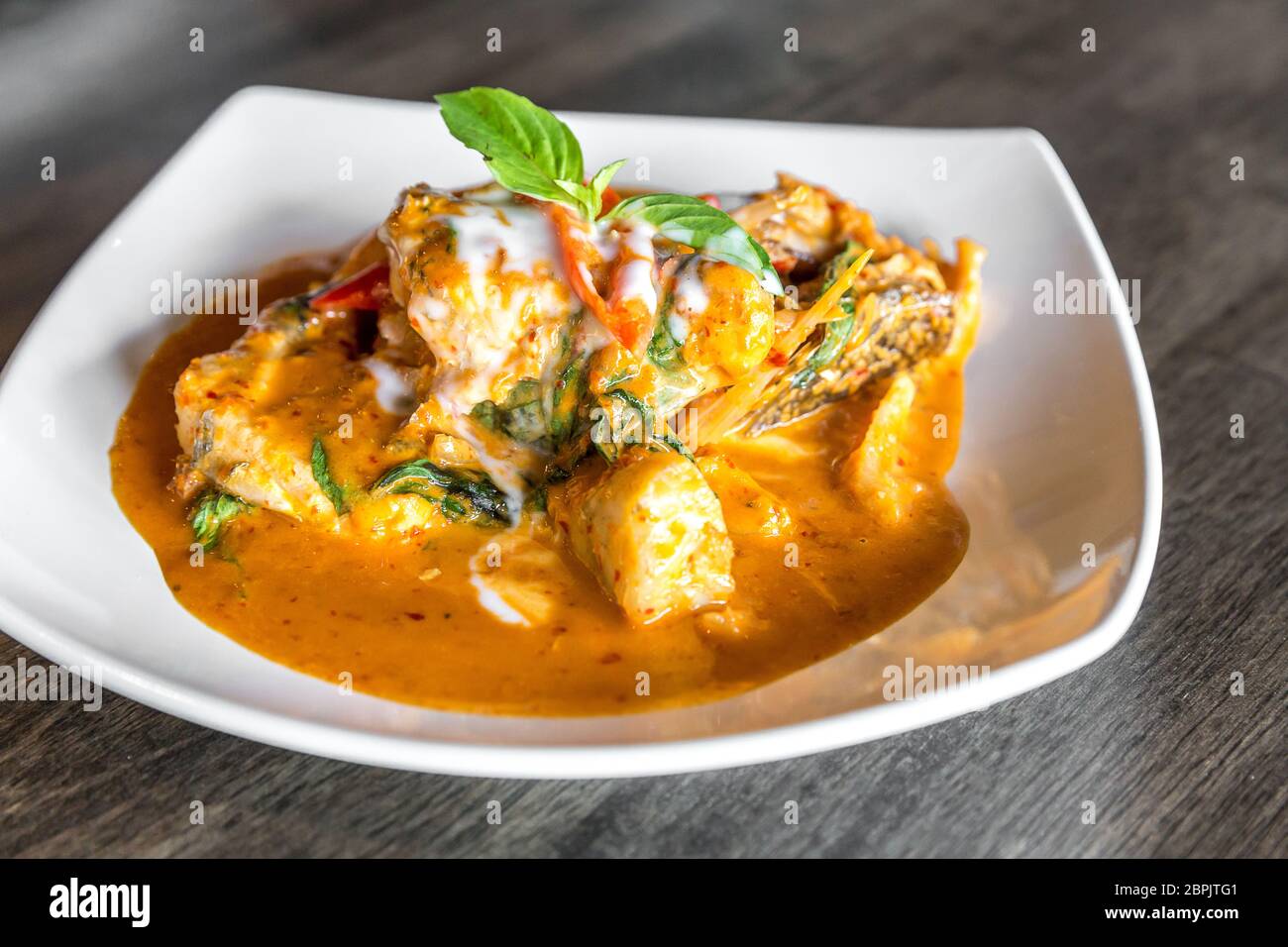 Fried grouper Fish with Red Curry Paste Chu Chee Pla Stock Photo - Alamy