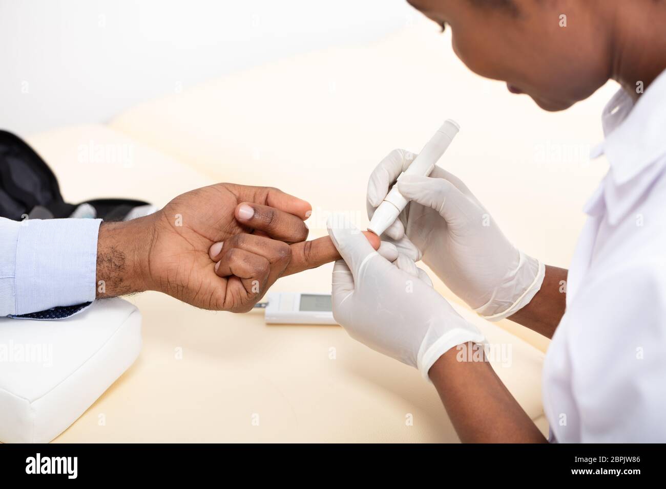 Close-up Of Female Doctor Checking Patient's Blood Sugar Level With ...