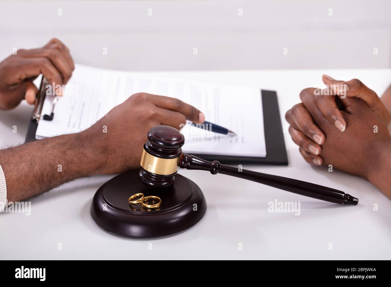 Close-up Of A Judge Explaining Contract To His Client With Gavel And ...