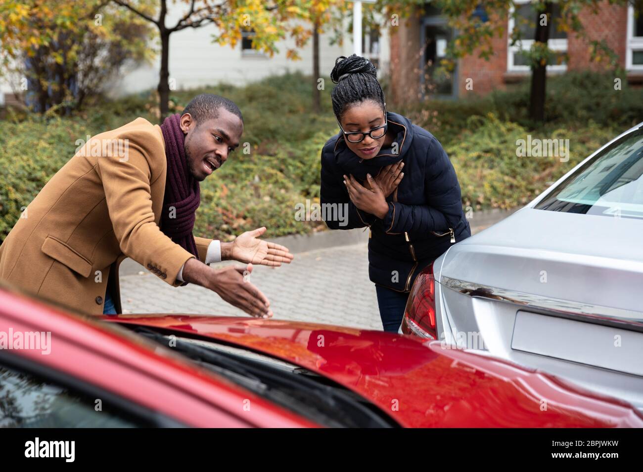 Woman standing on car bonnet hi-res stock photography and images - Alamy