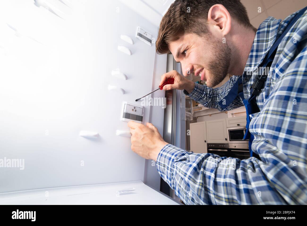 Technician examining refrigerator hi-res stock photography and images ...