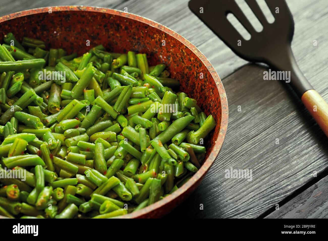 Vegetarian food. Fried string beans in a pan. Stylish background for ...