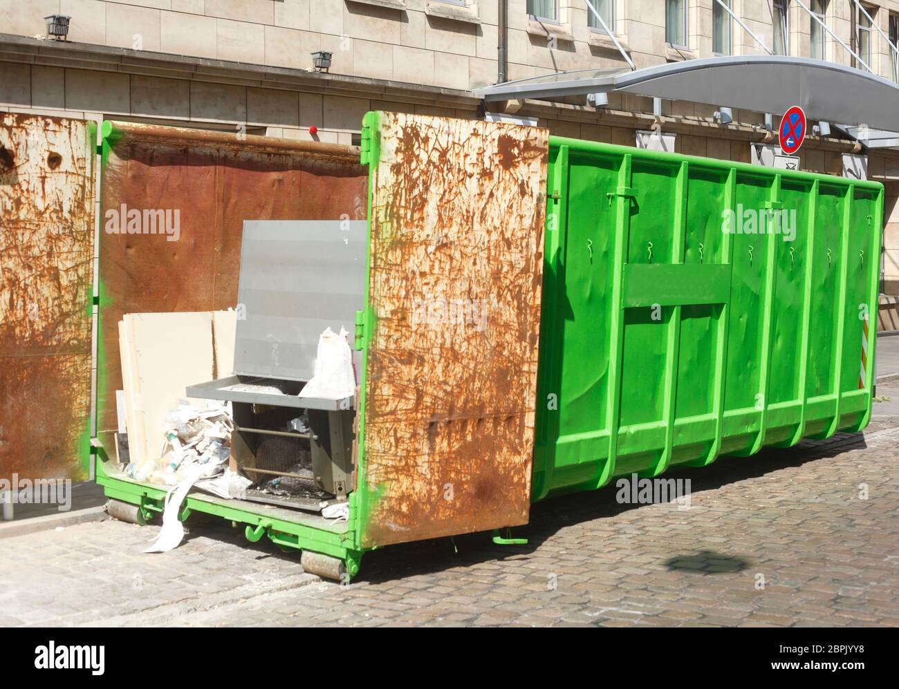 green Rubble Container on the street Stock Photo - Alamy