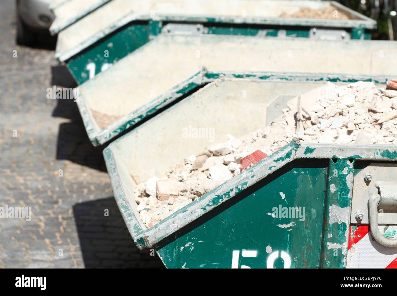green Rubble Container on the street Stock Photo - Alamy