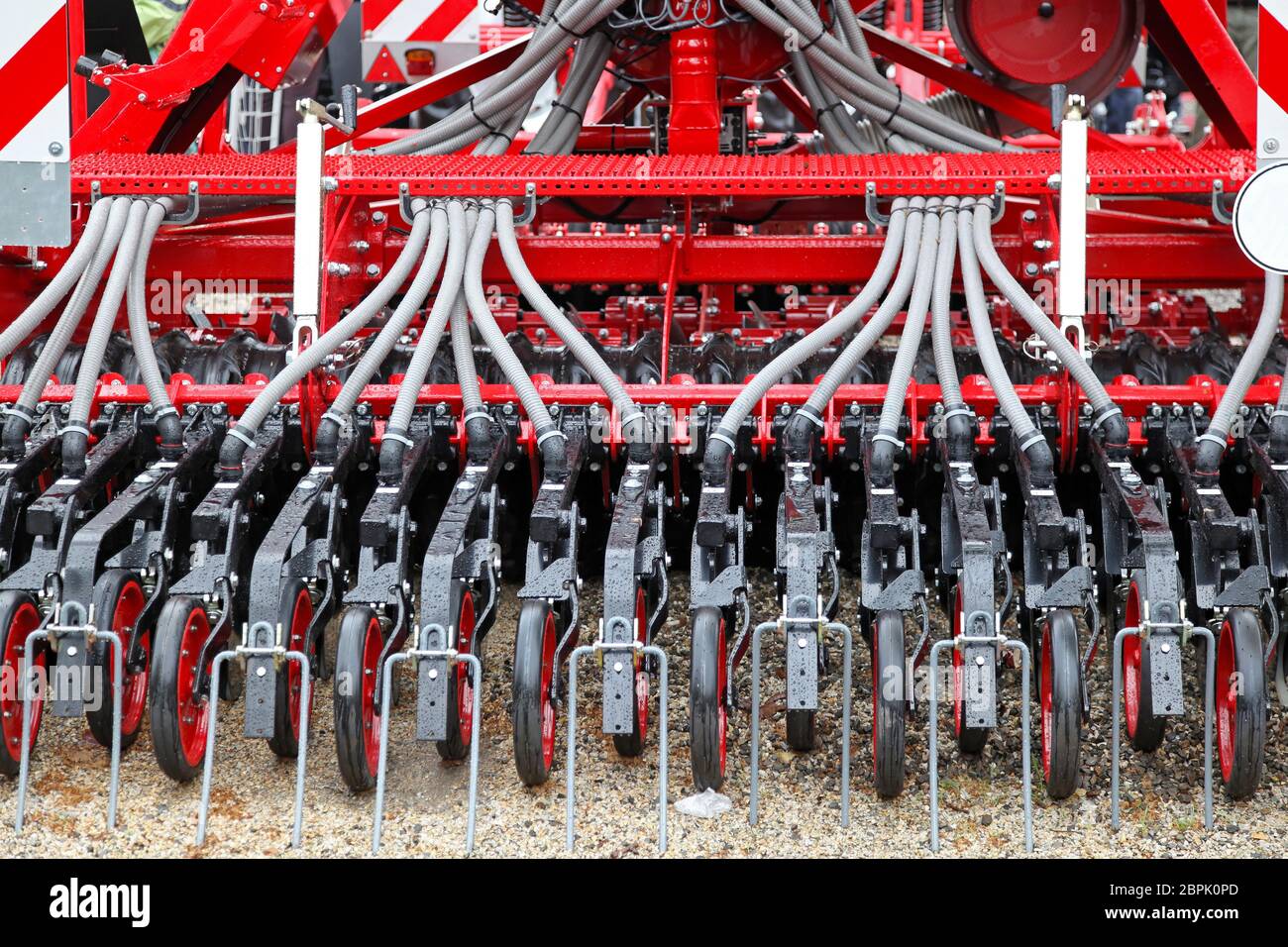 Red seeder planter row machine for agriculture Stock Photo - Alamy