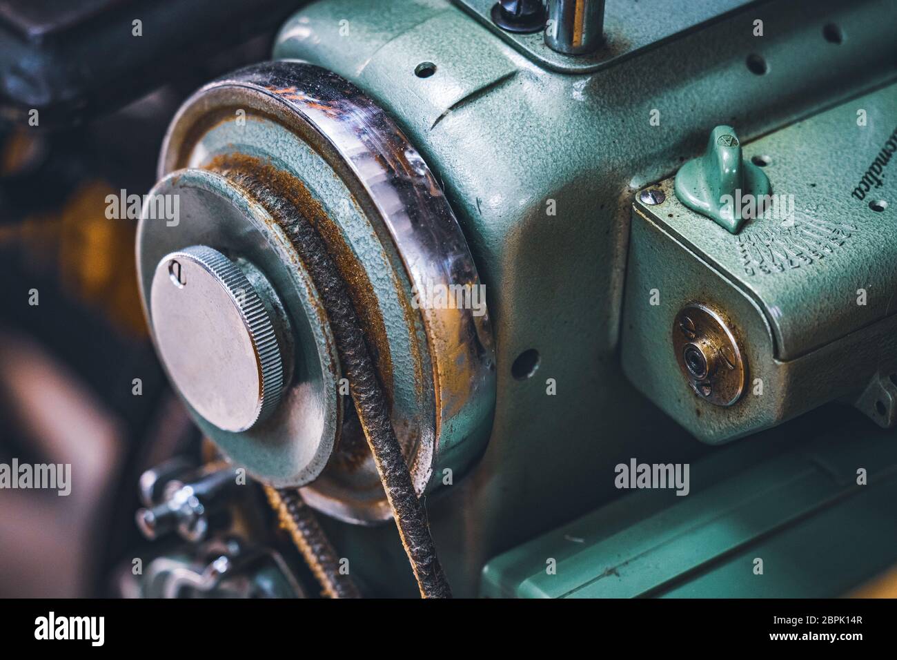 Detail from above of the balance wheel of a retro sewing machine with ...