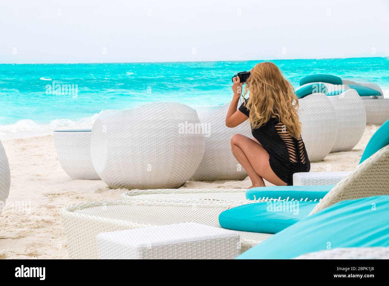 Beautiful woman doing photo shoot on the beach Stock Photo - Alamy