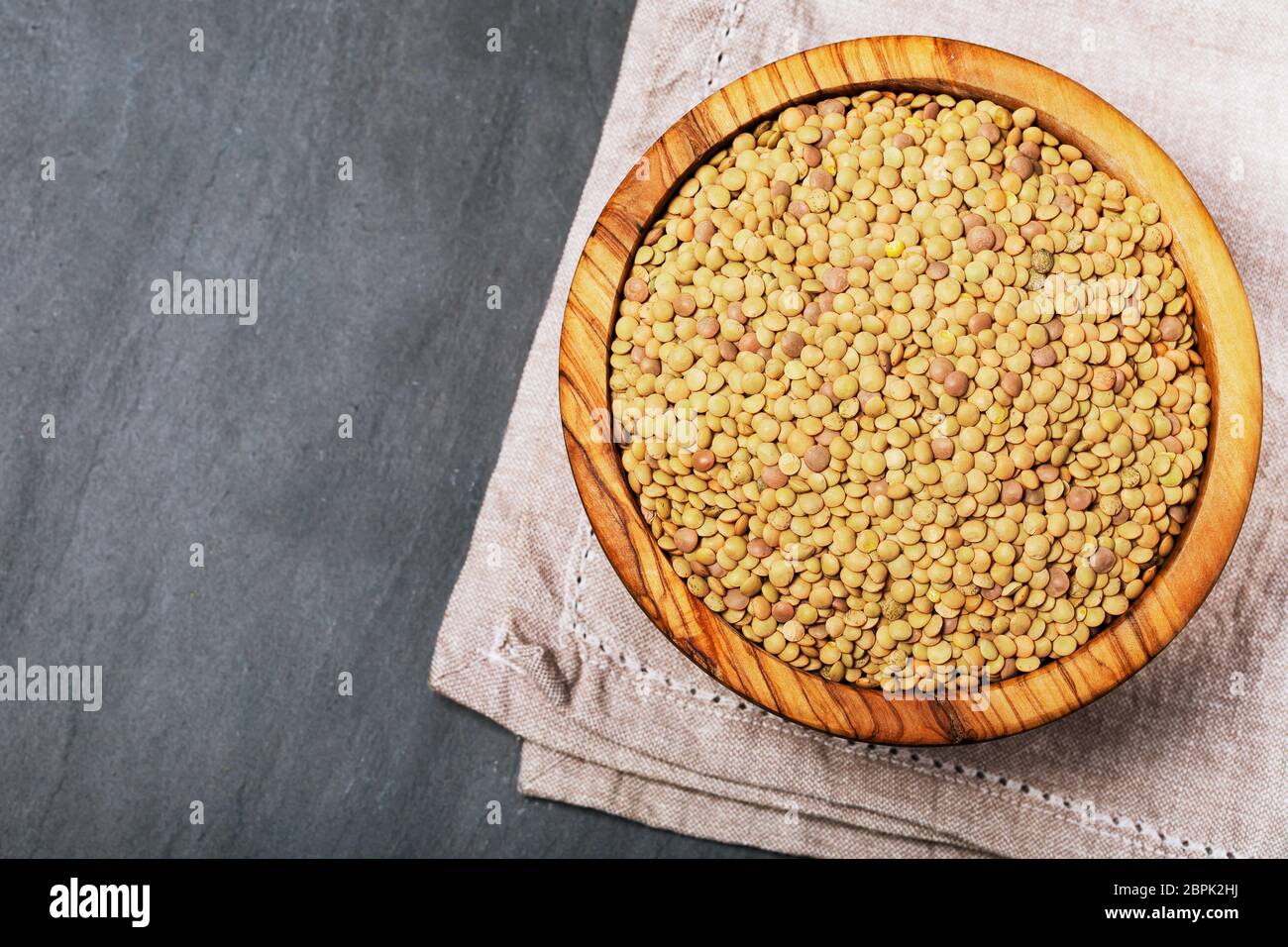 Raw lentils on balck stone background. Healthy vegetarian food concept ...