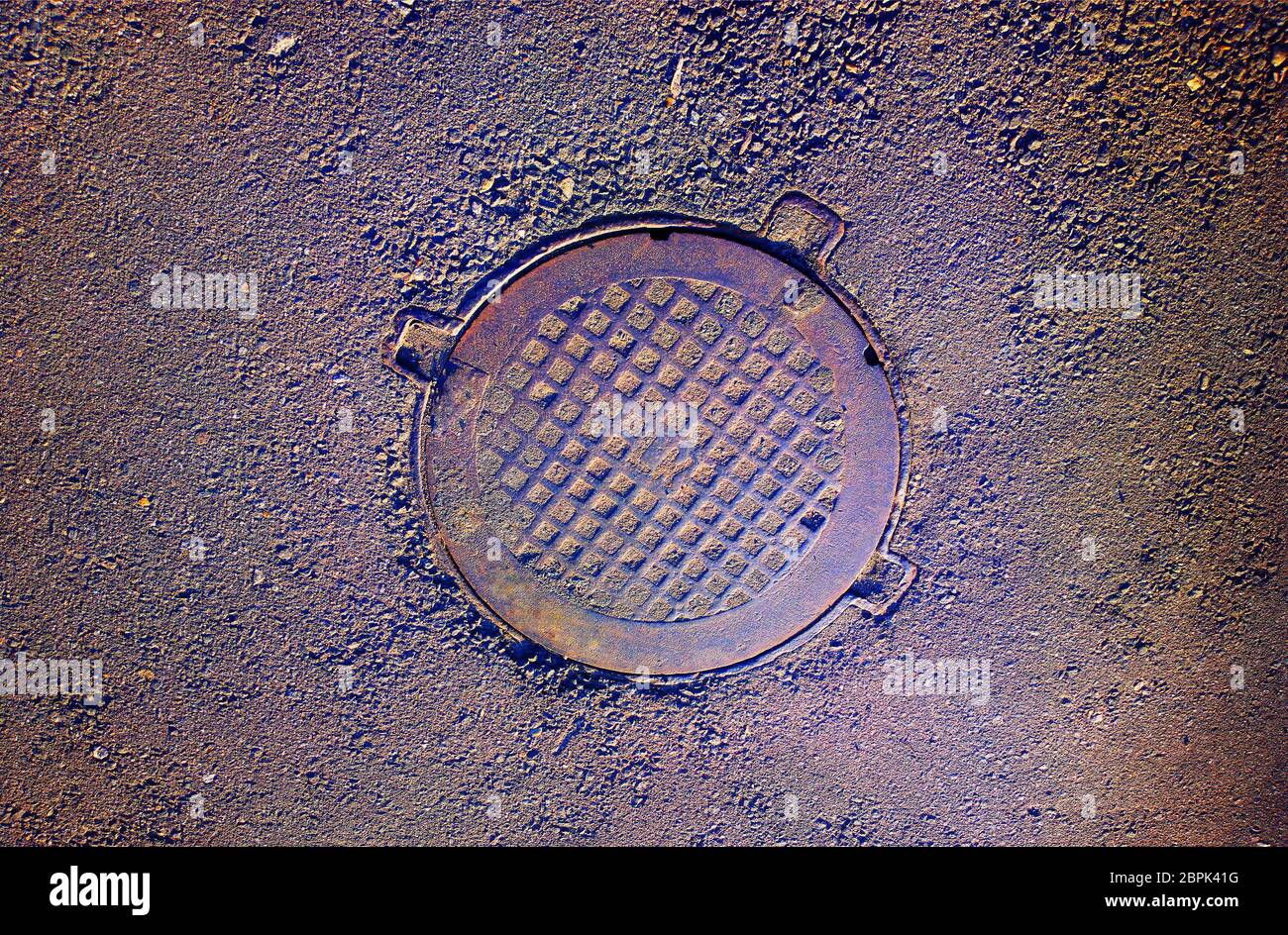 Locked sewer manhole object background Stock Photo - Alamy