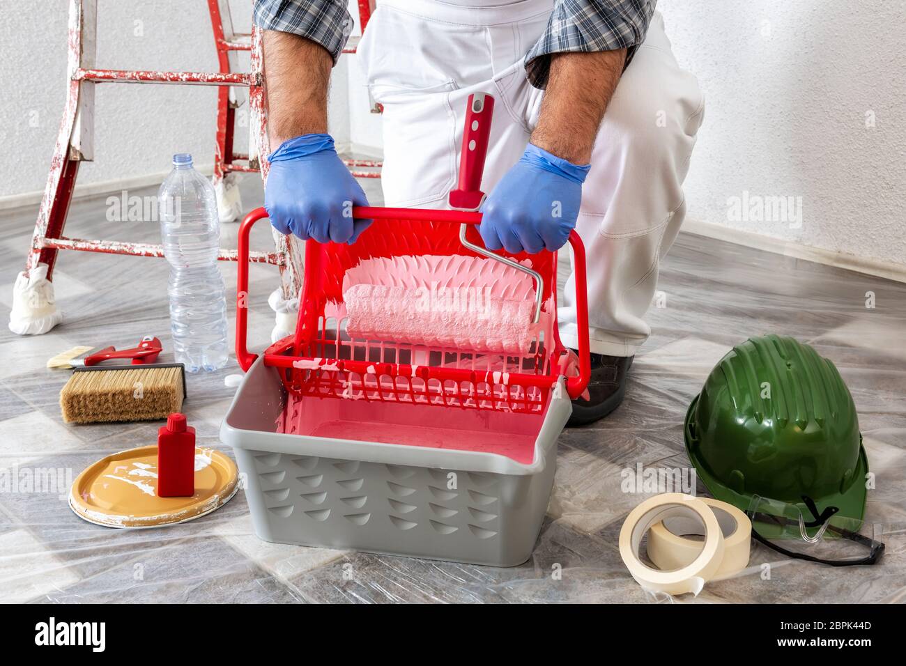 Caucasian worker house painter at work, preparing the paint for ...