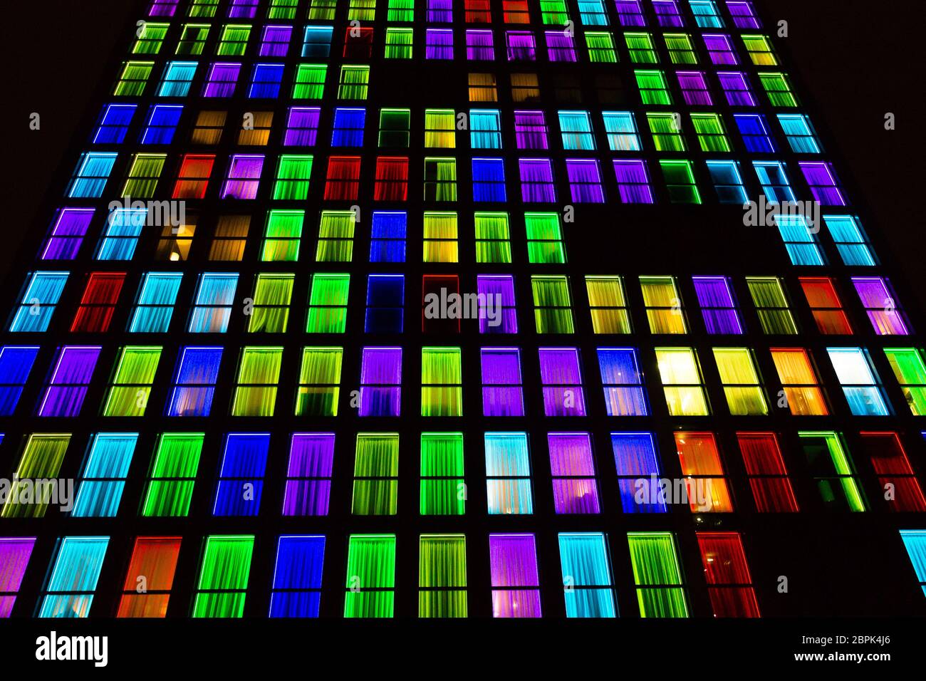 Colored windows texture. Windows illuminated by neon lights background ...