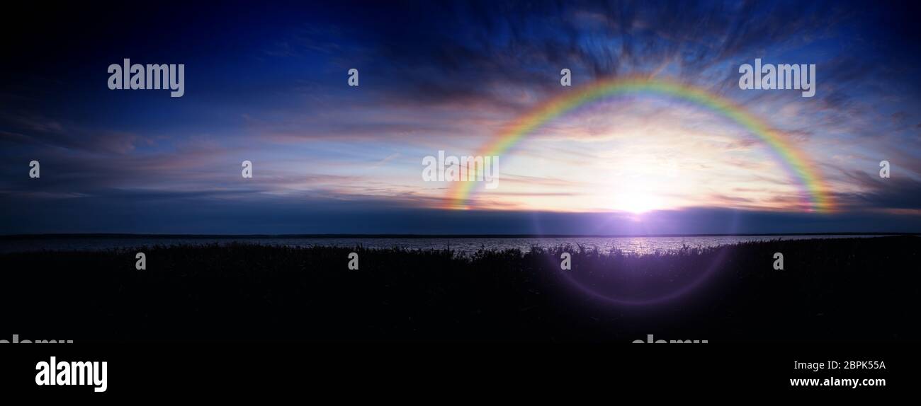 Dramatic rainbow at sunset river landscape background Stock Photo - Alamy