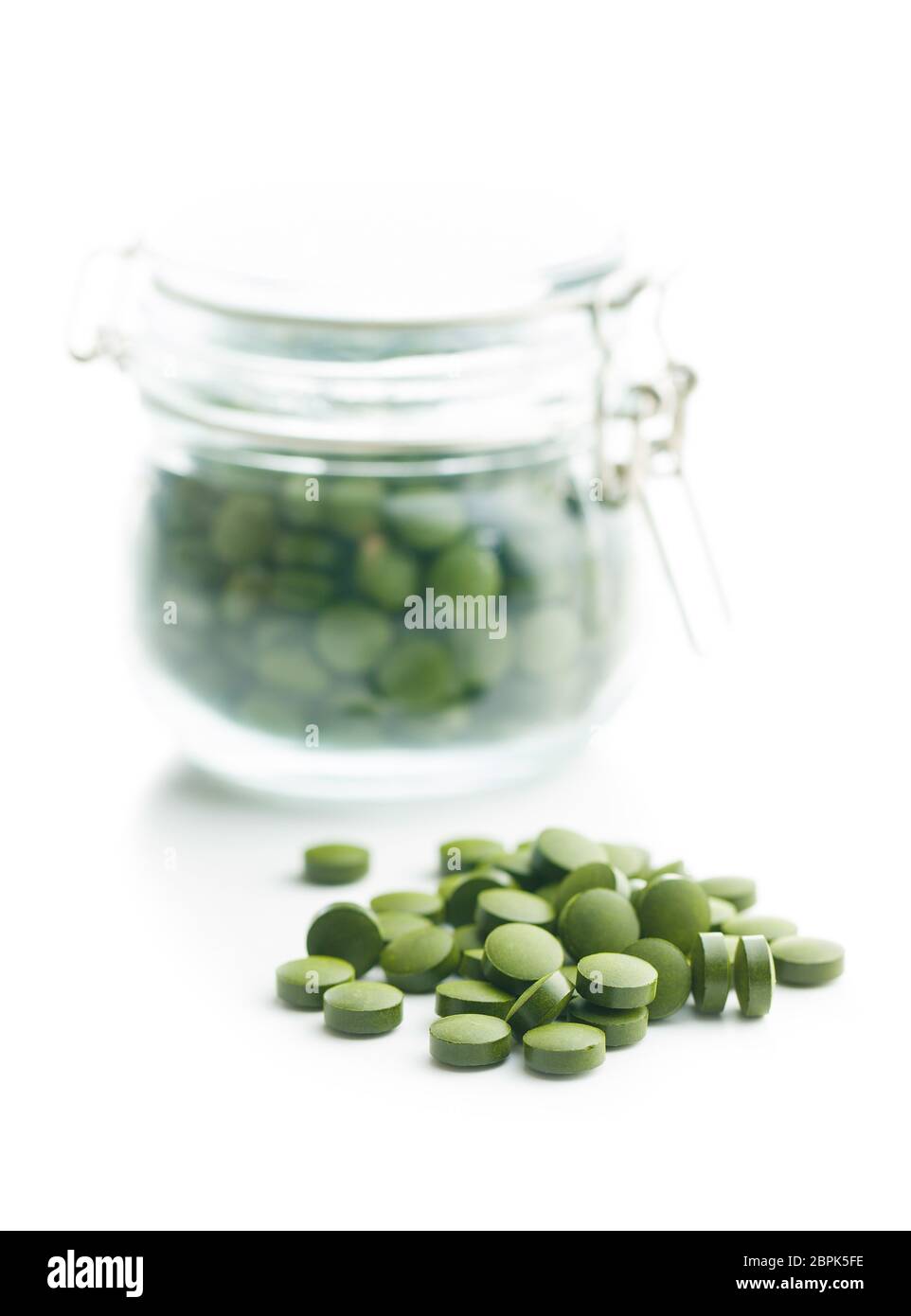 Green chlorella pills or green barley pills isolated on white ...