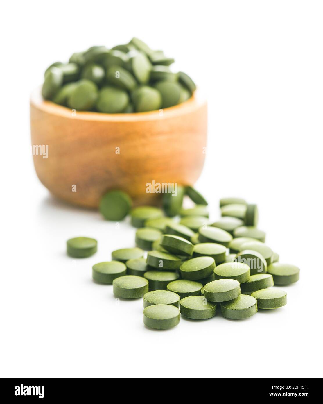 Green chlorella pills or green barley pills isolated on white ...