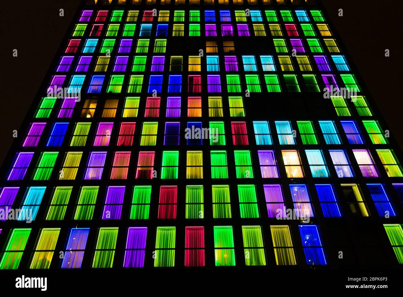 Colored windows texture. Windows illuminated by neon lights background ...