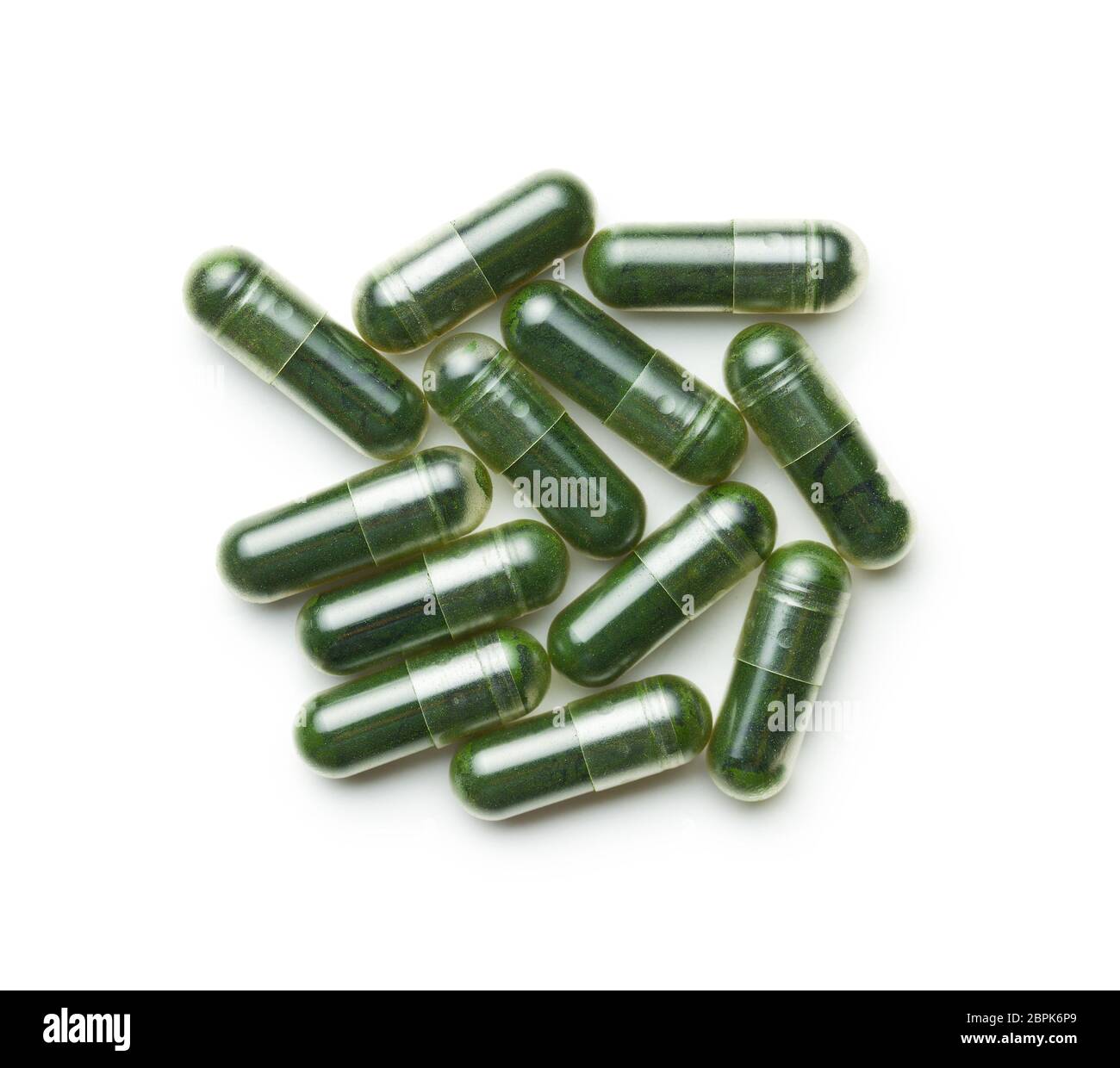 Green chlorella pills or green barley pills isolated on white ...