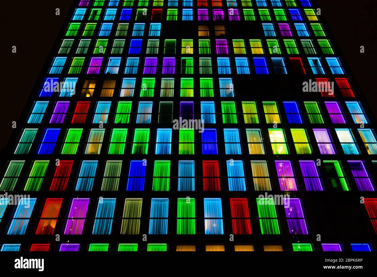 Colored windows texture. Windows illuminated by neon lights background ...
