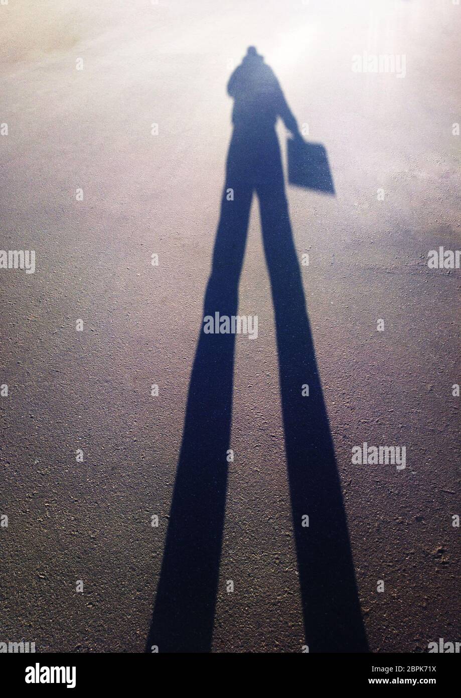 Shadow of the standing man holding piece of paper background Stock ...