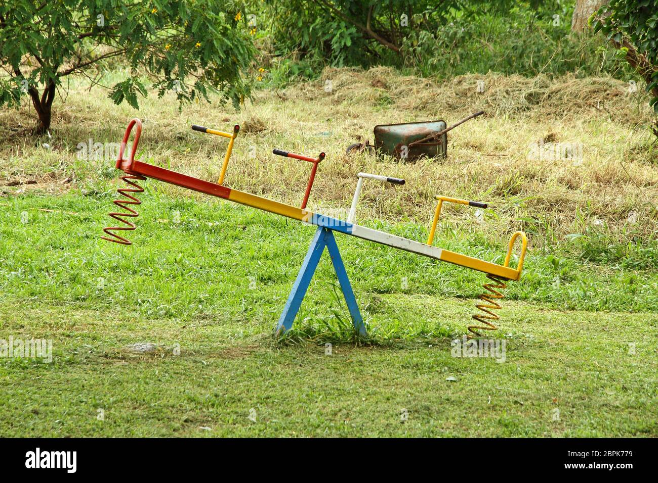 An old, but colorful, see saw in an African playground area Stock Photo ...