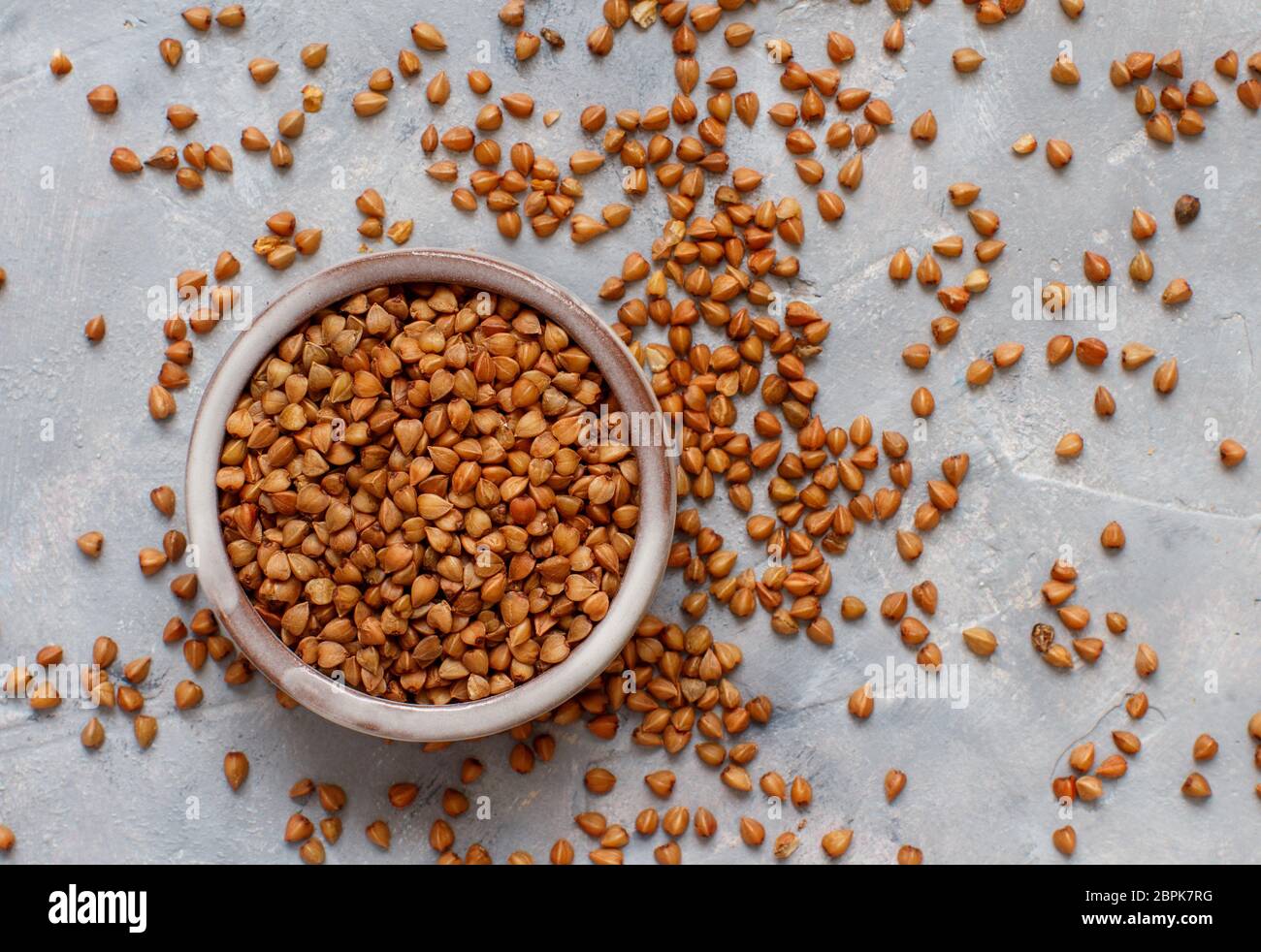 Raw dry buckwheat grain in a bowl with a spoon top view Stock Photo - Alamy