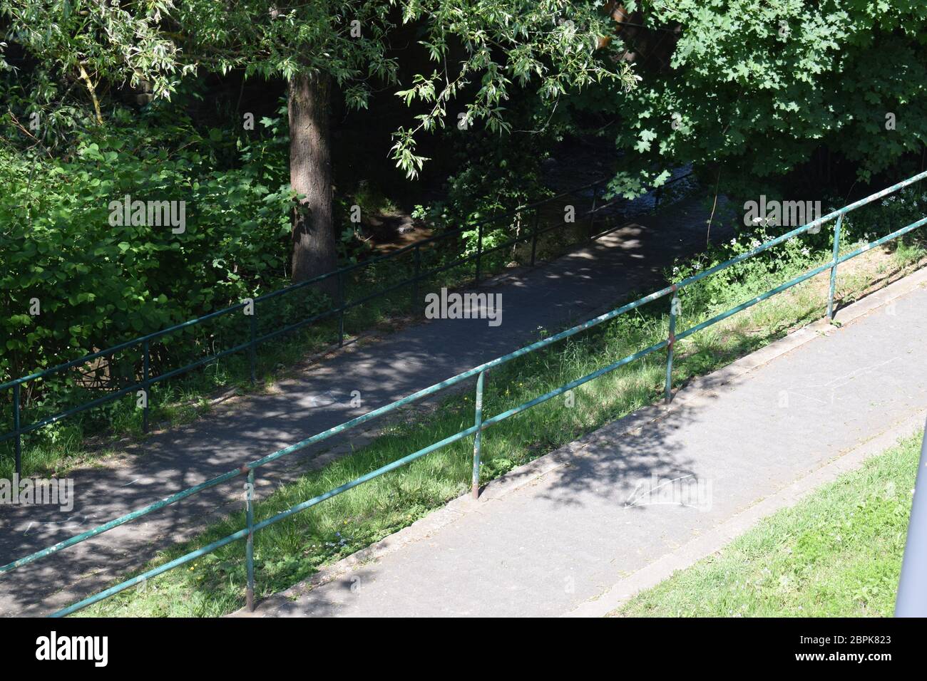 twisted way down into a small river valley Stock Photo - Alamy