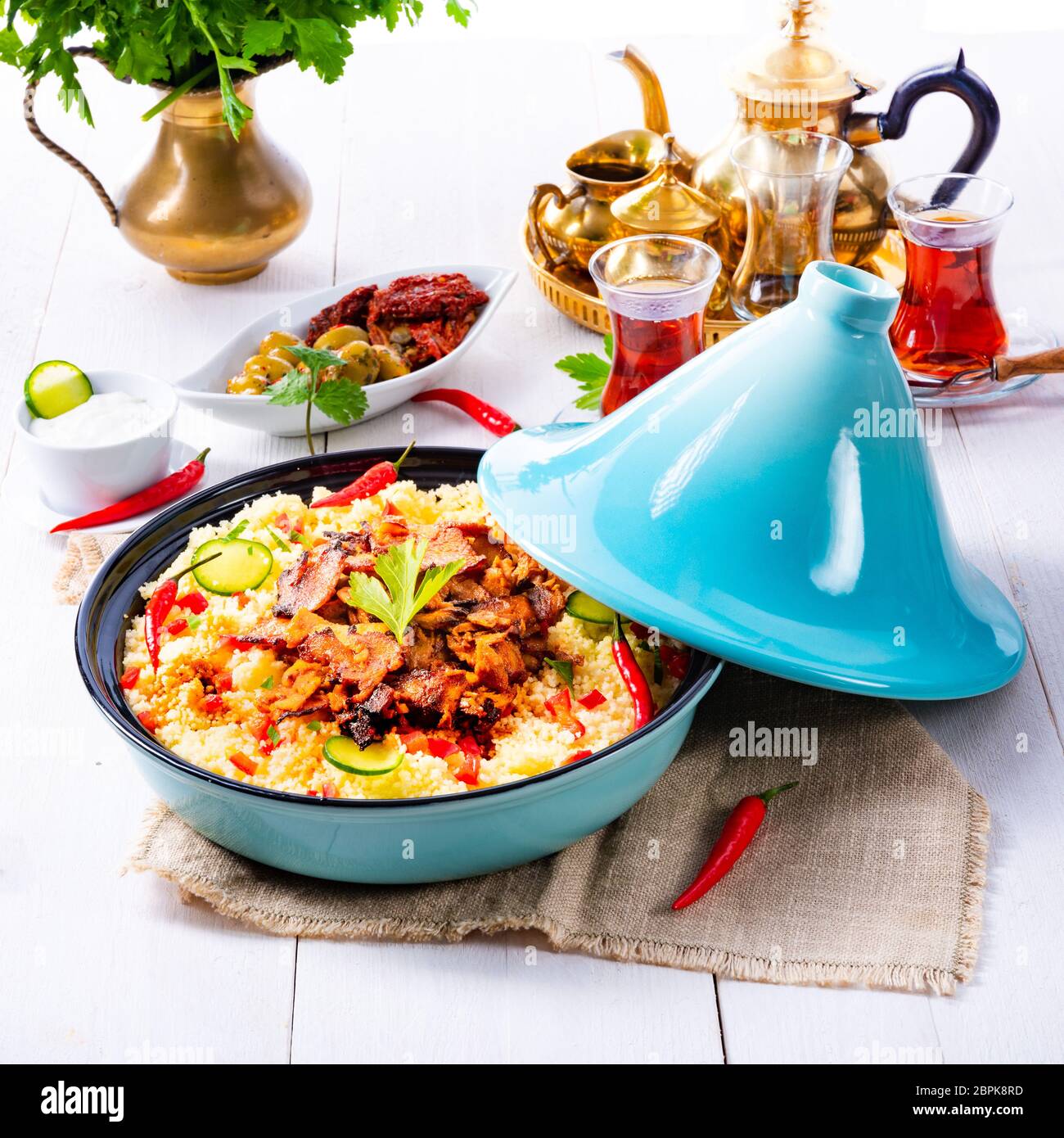 Tajin with couscous, vegetables and meat on white background Stock ...
