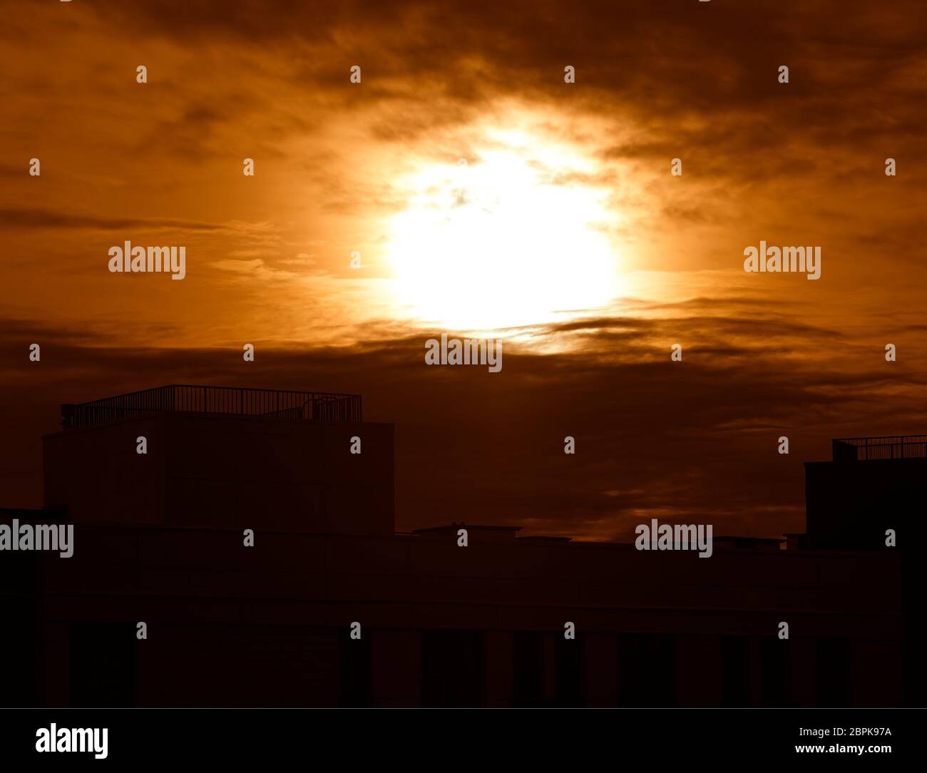 Burning sunset at city roof background Stock Photo - Alamy