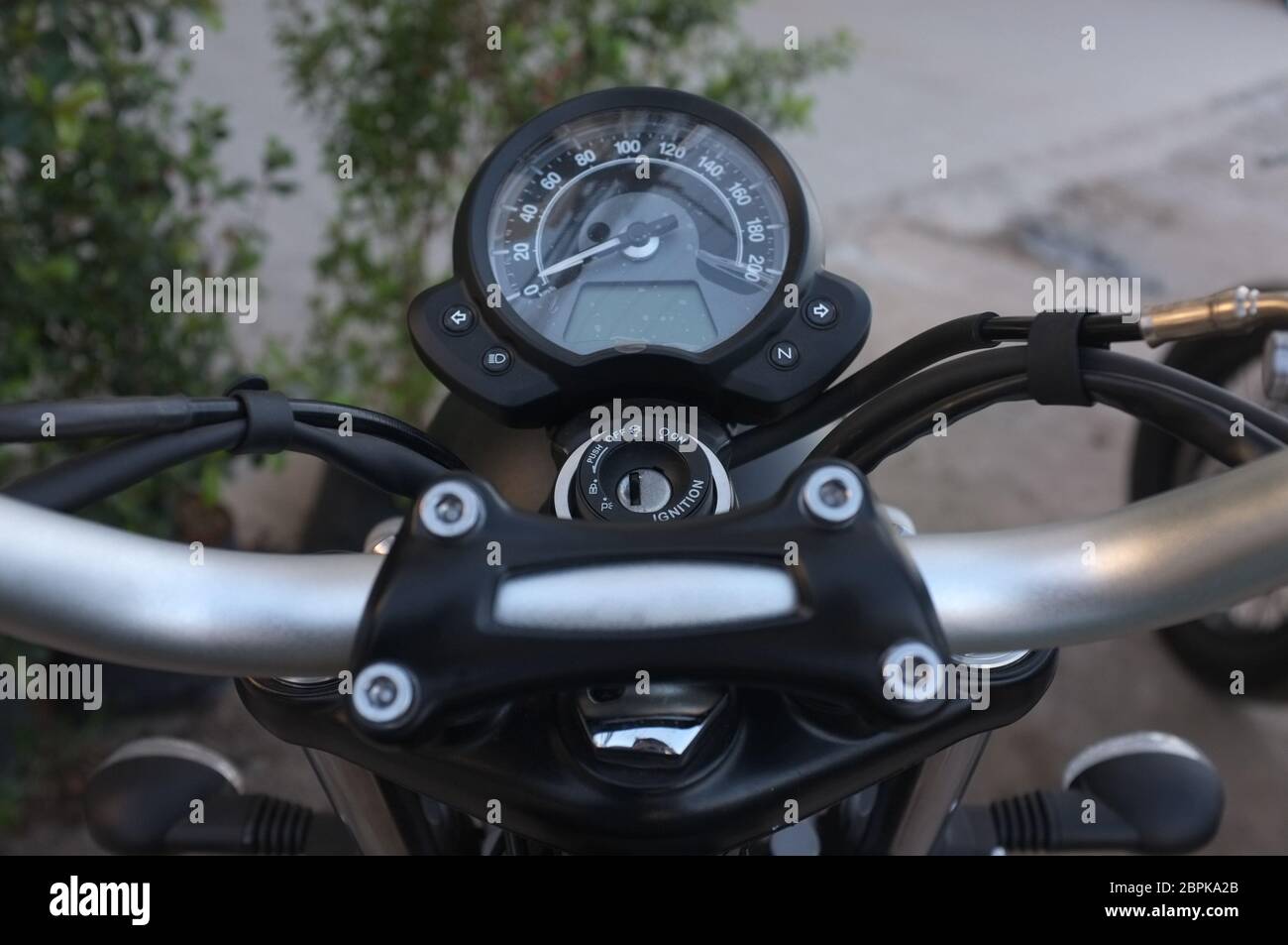 Motorcycle handlebar controls including speedometer Stock Photo - Alamy