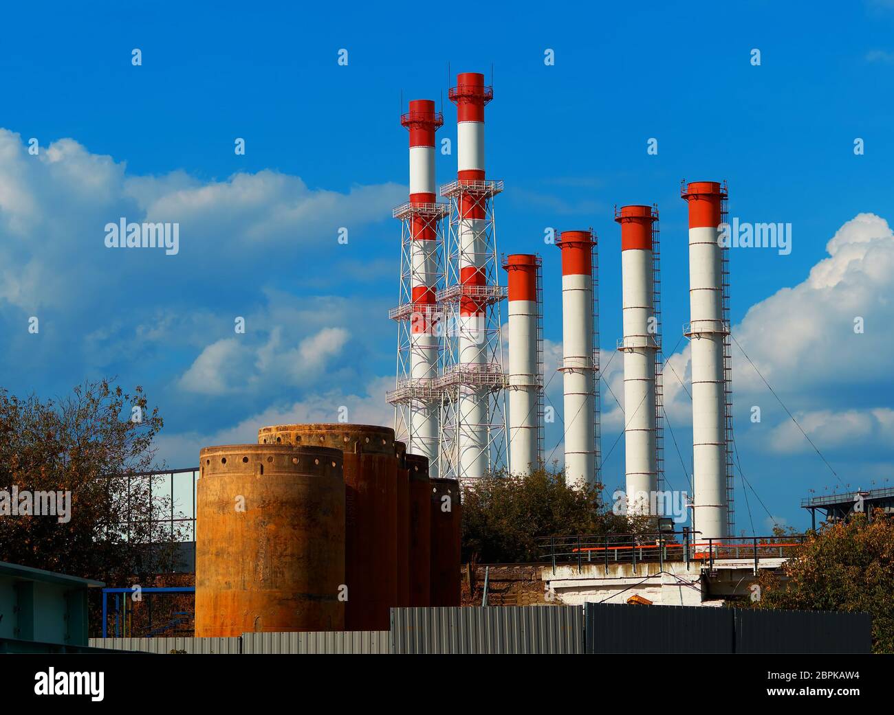 Multiple industrial chimneys industrial ecology background Stock Photo ...