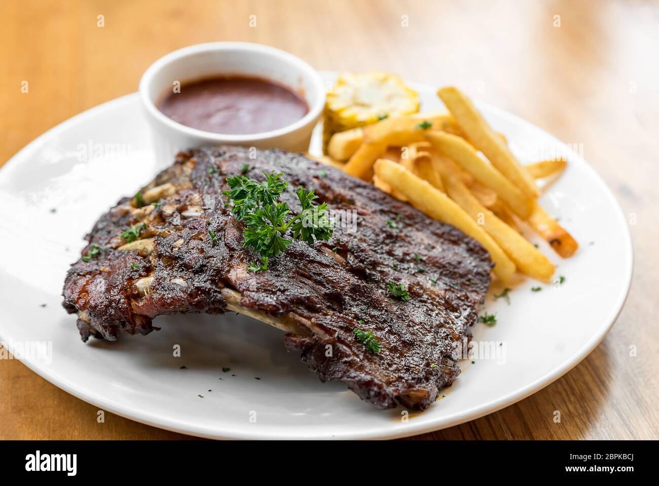 Grilled Barbecued Pork Baby Back Ribs with grilled sweet corn and fries ...